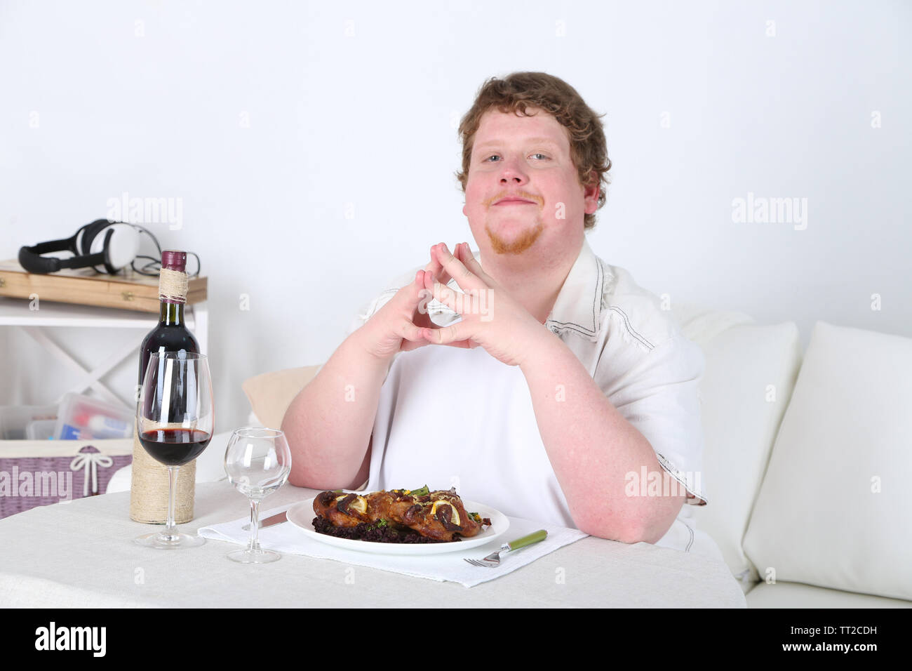 Tasty lunch for fat man, on home interior background Stock Photo - Alamy