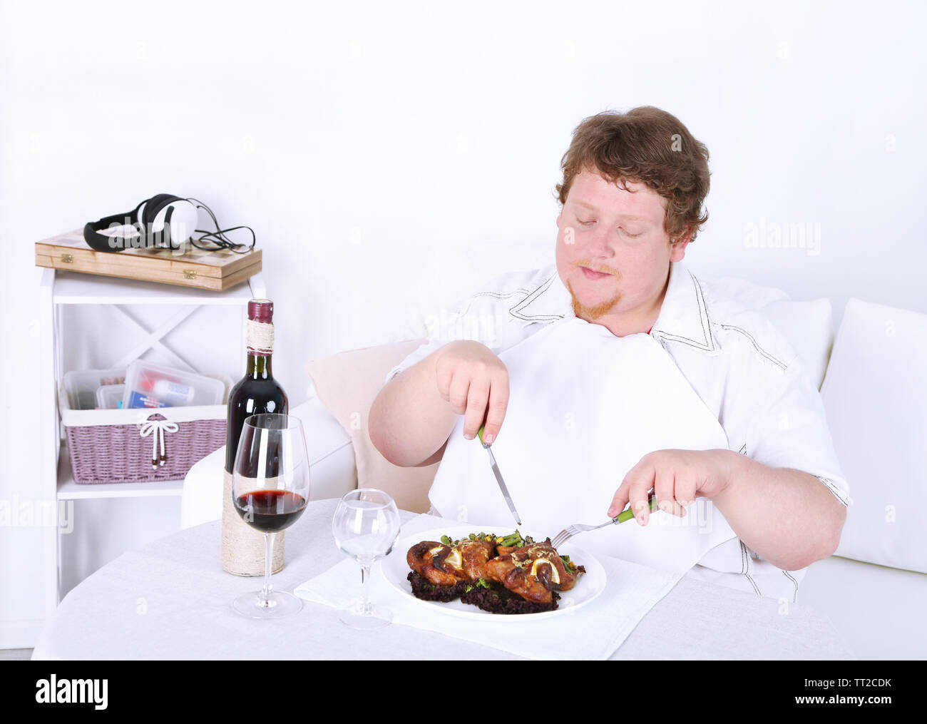 Tasty lunch for fat man, on home interior background Stock Photo - Alamy