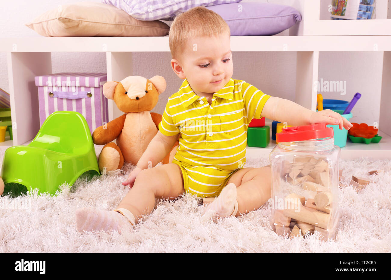 Cute little boy with toys in room Stock Photo - Alamy