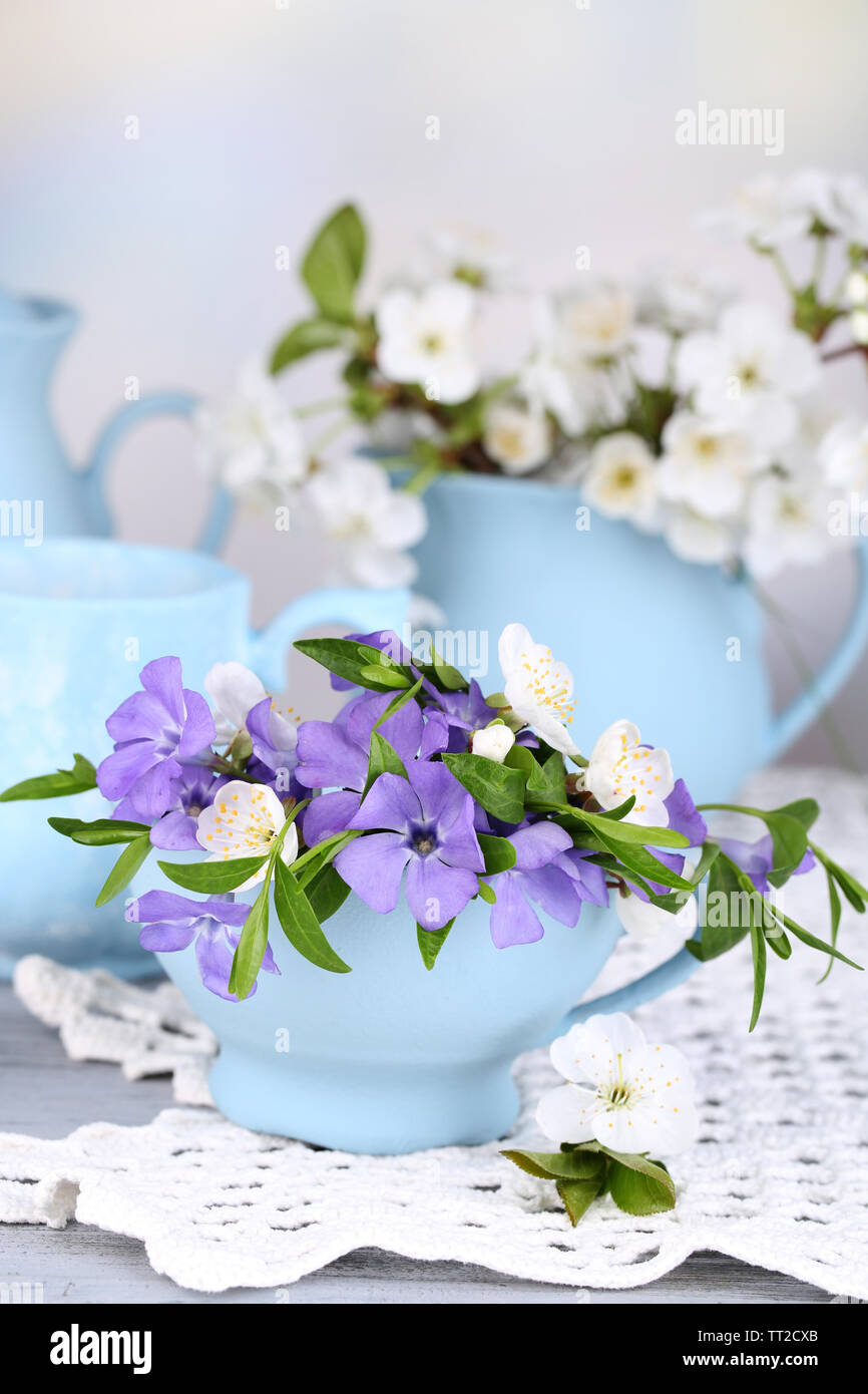 Beautiful spring flowers in cups on wooden table Stock Photo - Alamy