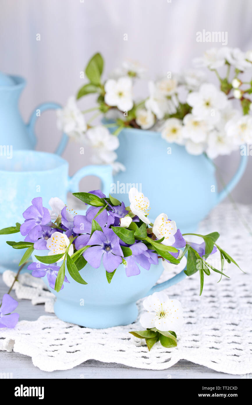 Beautiful spring flowers in cups on wooden table Stock Photo - Alamy