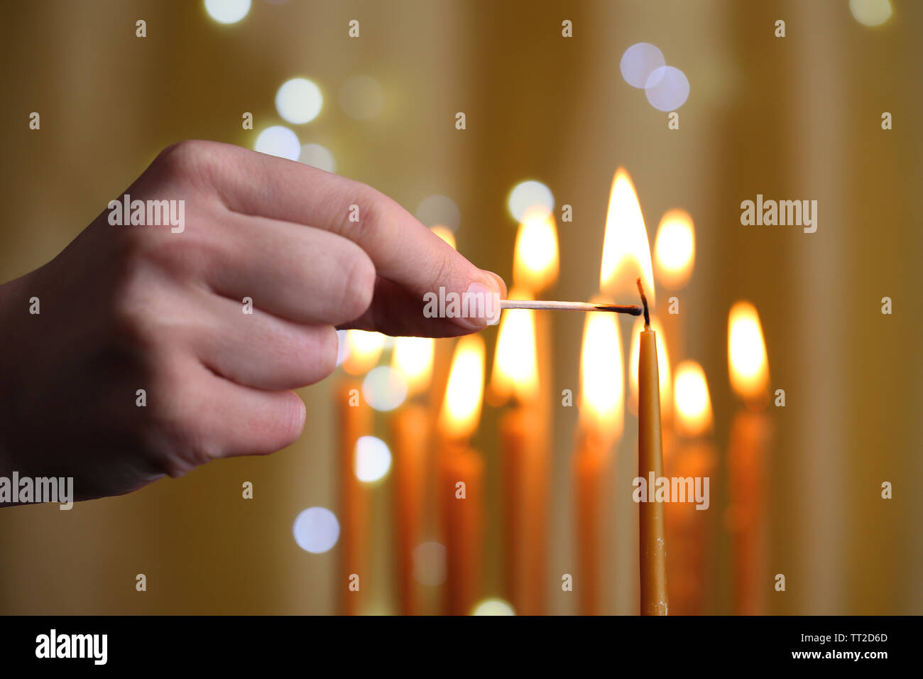 Hand lighting candle Stock Photo - Alamy
