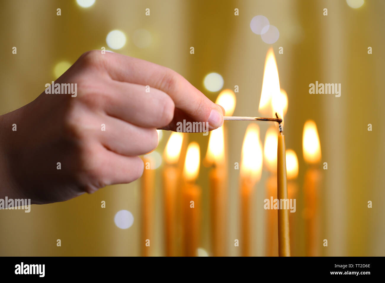 Hand lighting candle Stock Photo - Alamy