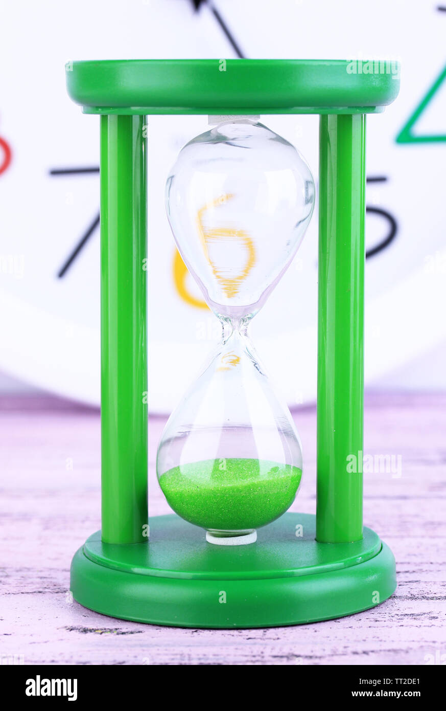 Hourglass and big clock on light background Stock Photo - Alamy