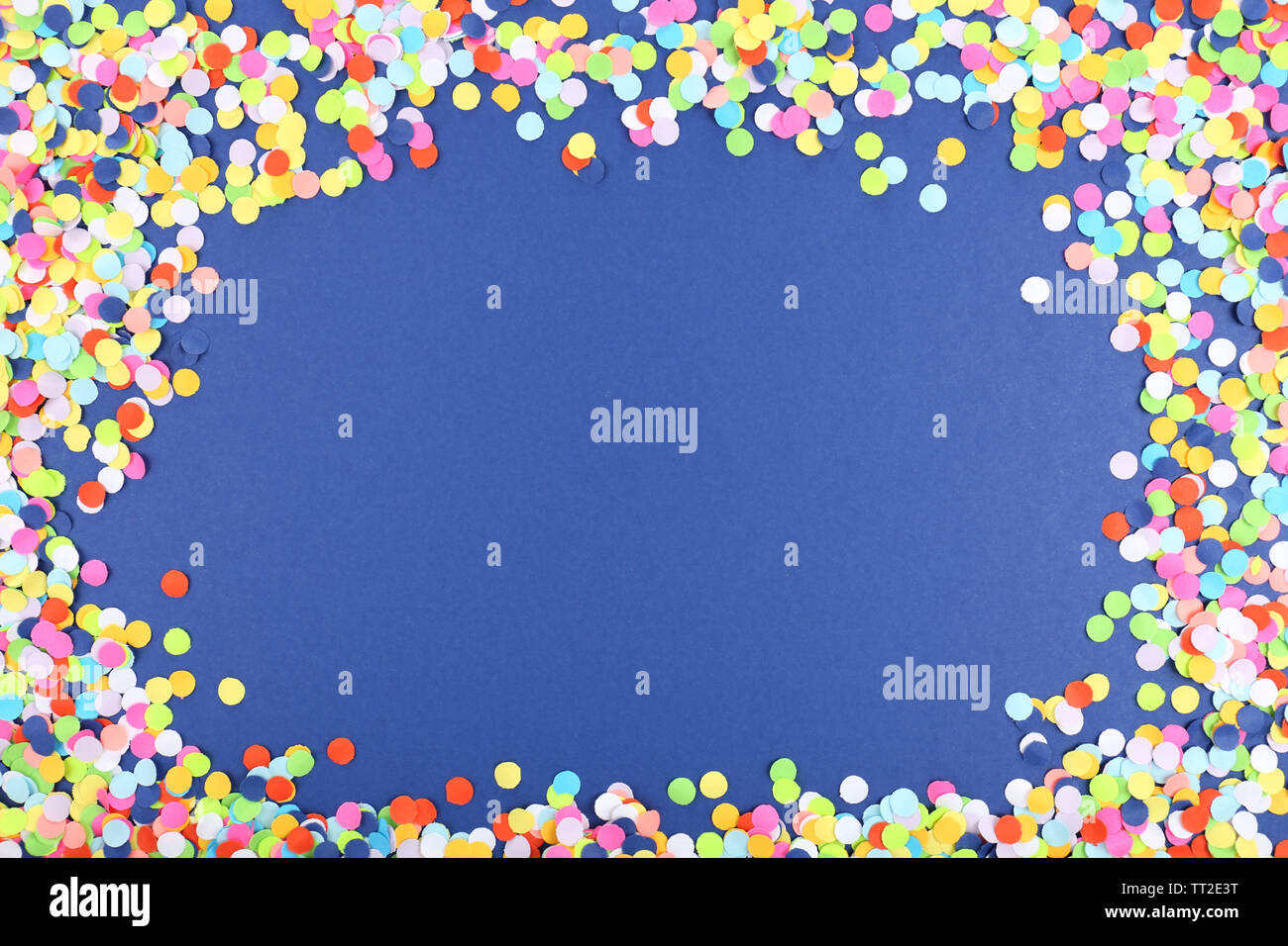 Confetti frame on blue background Stock Photo - Alamy