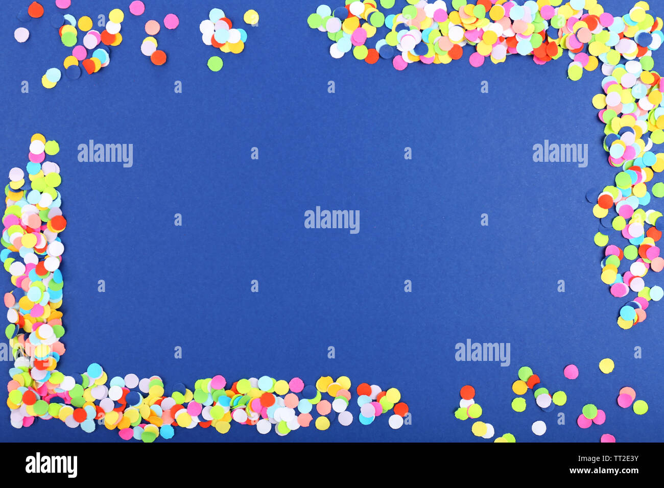 Confetti frame on blue background Stock Photo - Alamy