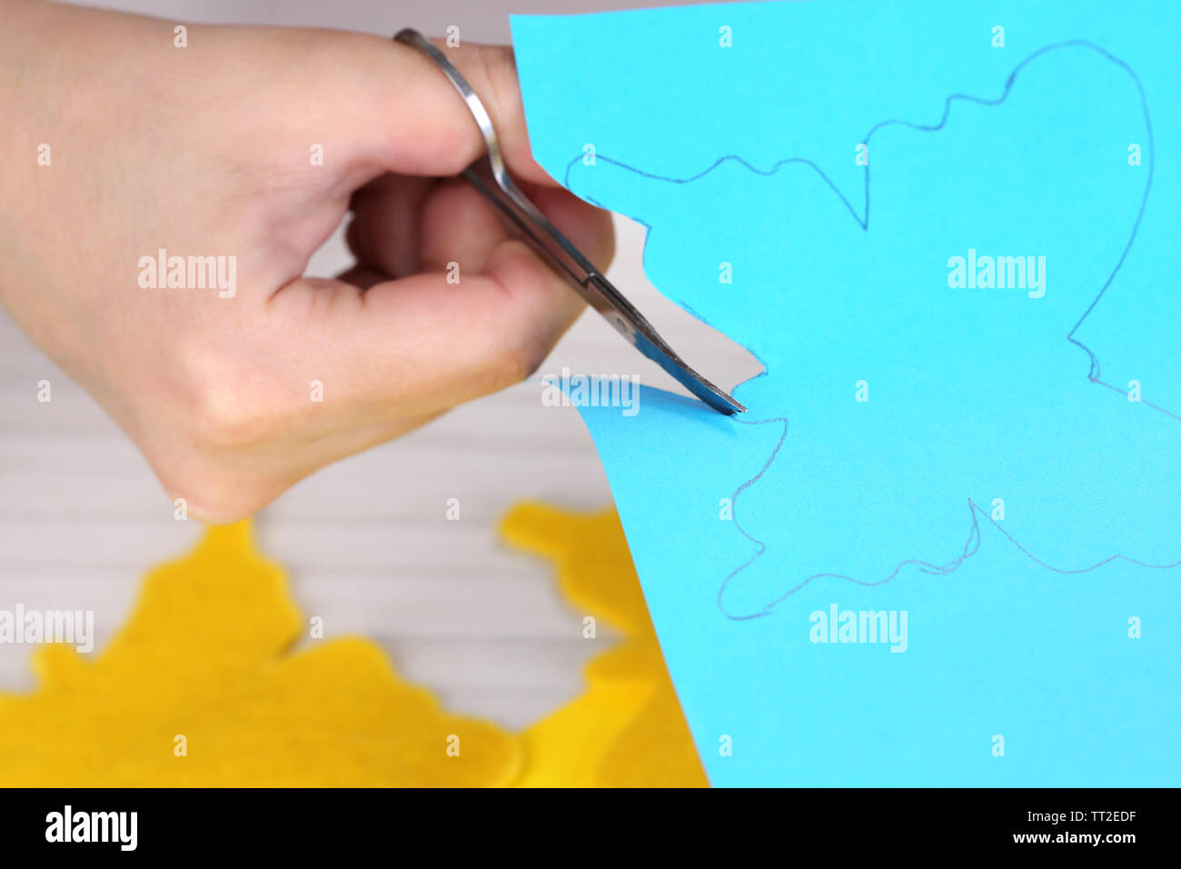 Women hand cutting colorful paper with scissors Stock Photo - Alamy