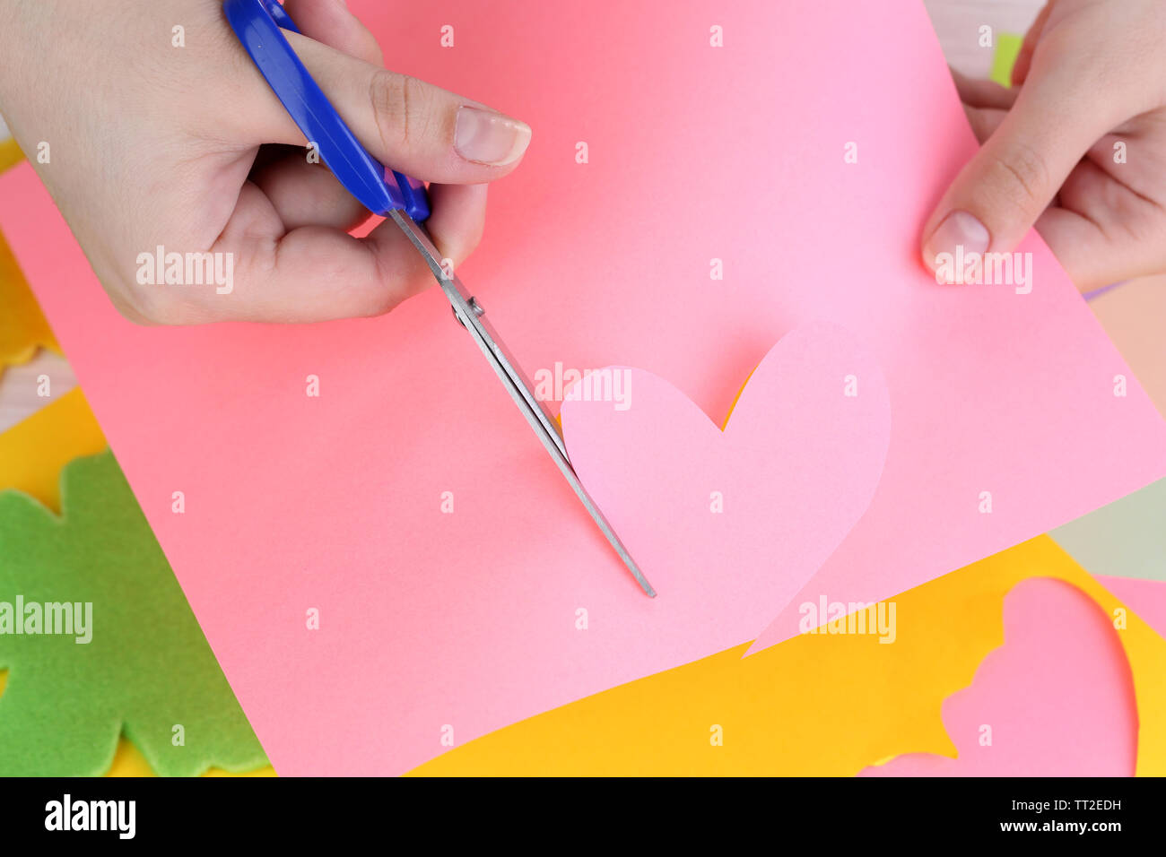 Women hand cutting colorful paper with scissors Stock Photo - Alamy