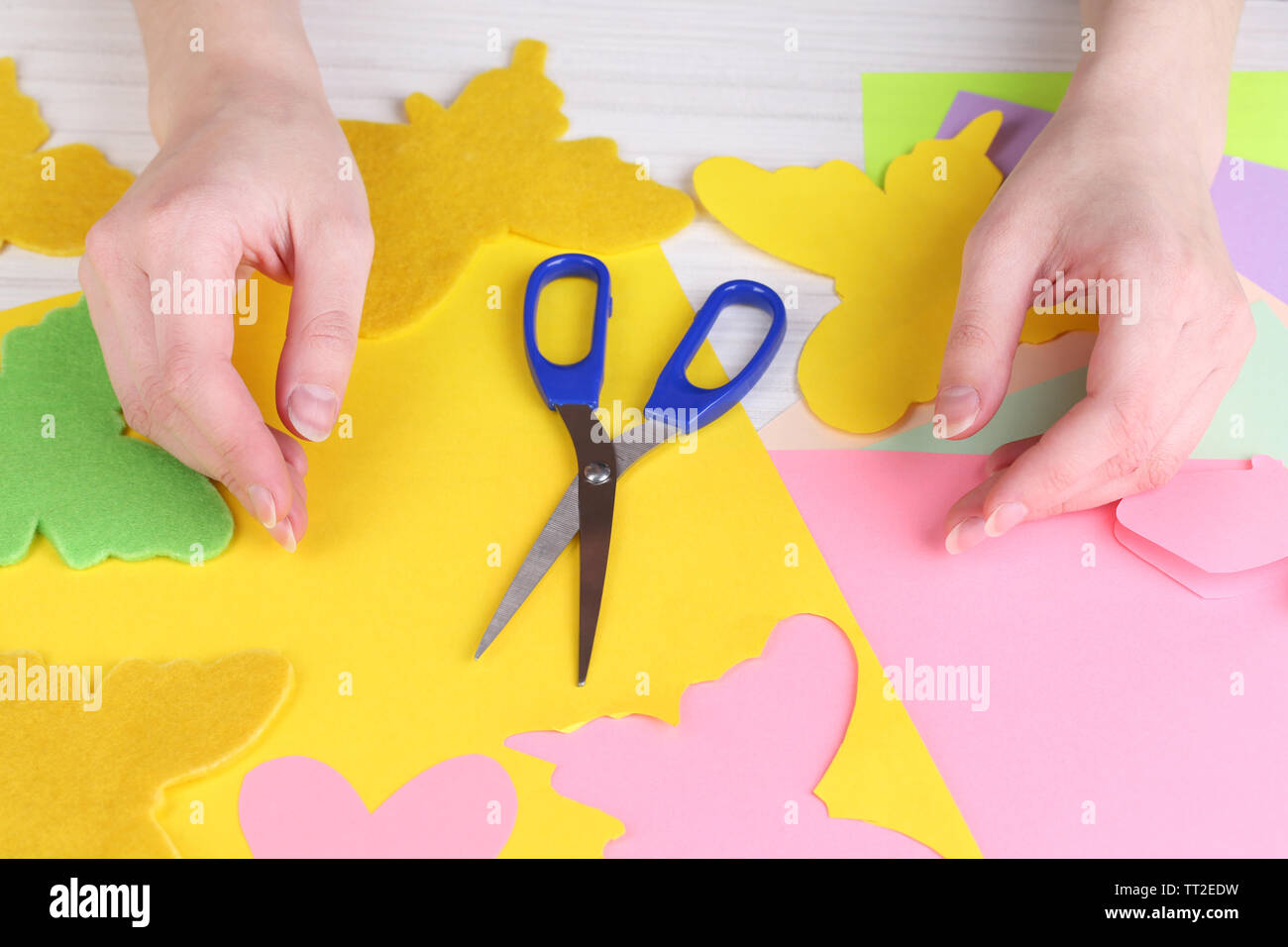 Women hand cutting colorful paper with scissors Stock Photo - Alamy