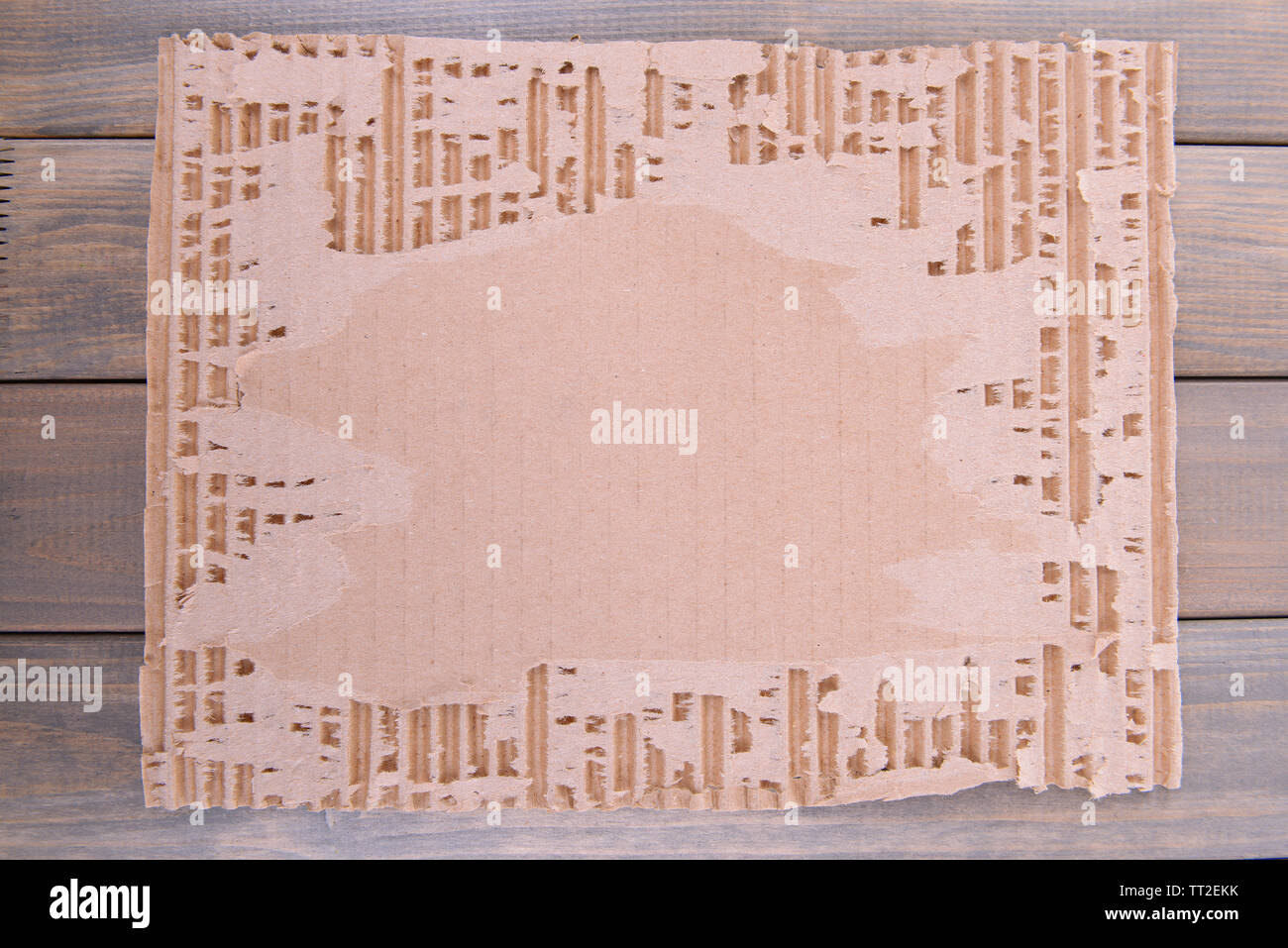 Cardboard on wooden background Stock Photo - Alamy