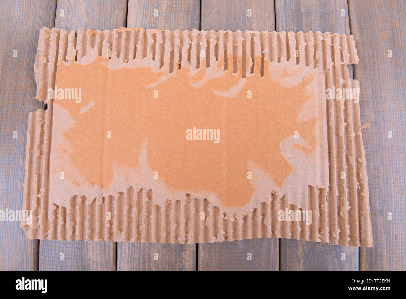 Cardboard on wooden background Stock Photo - Alamy