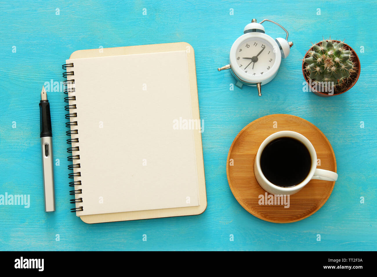 Open notebook with empty pages and other office supplies over blue ...