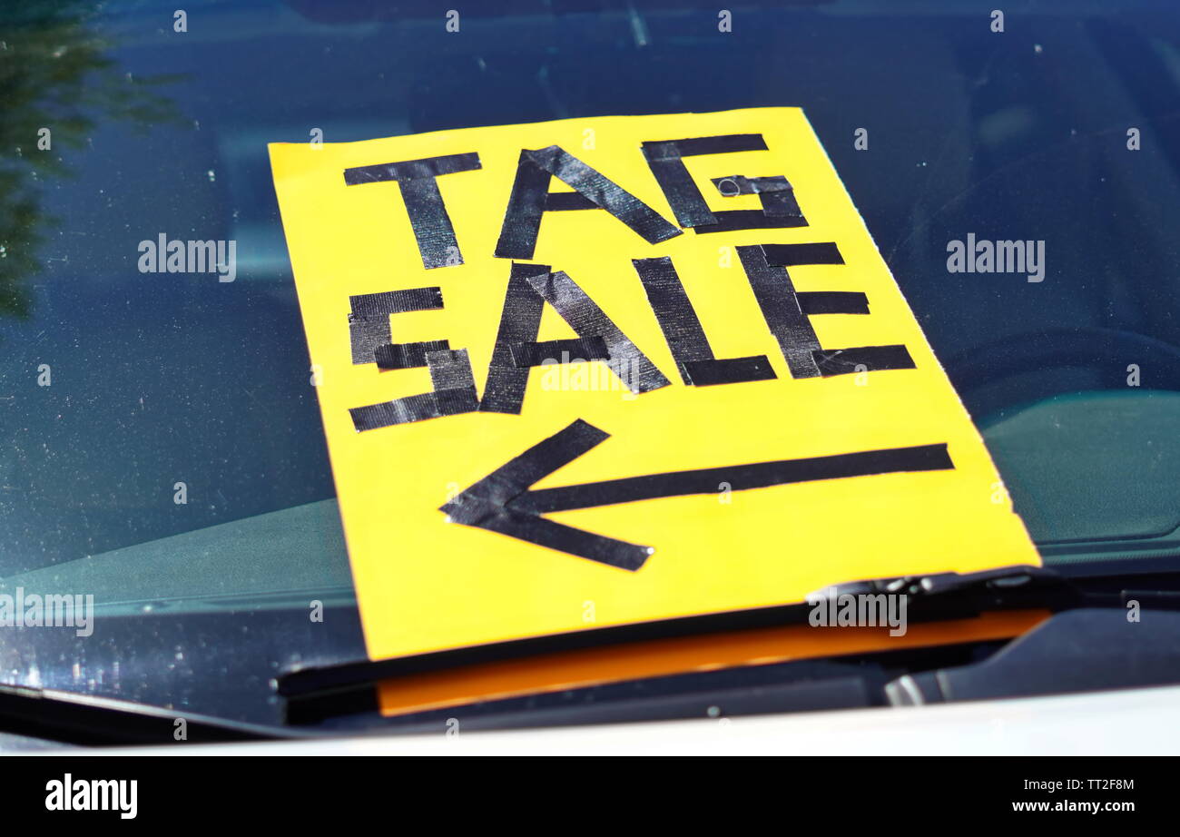 Sign advertising a local tag sale Stock Photo - Alamy