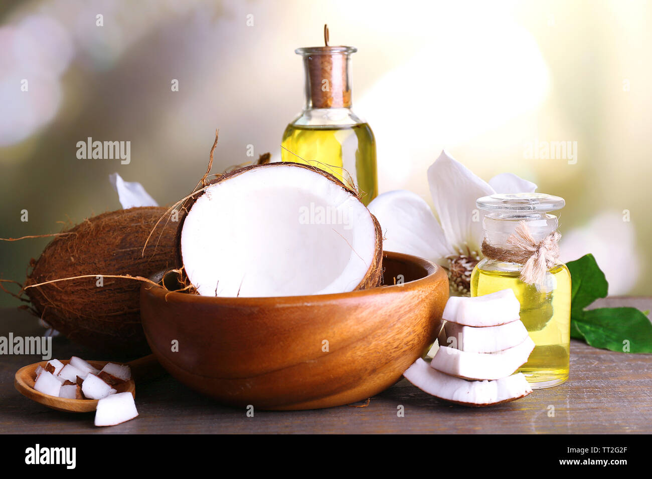 Coconuts and coconut oil on wooden table Stock Photo - Alamy
