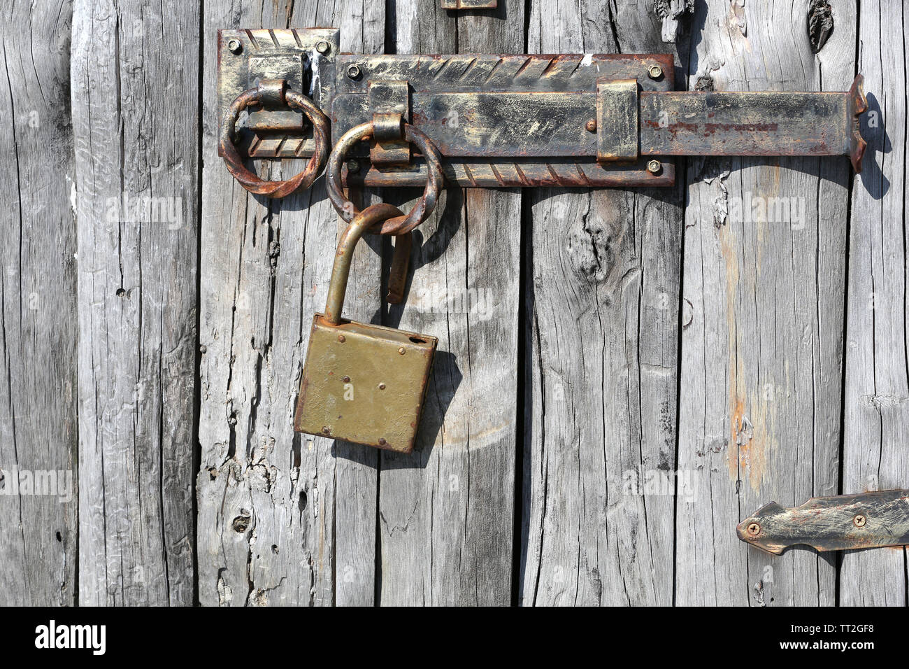 Wooden door with big lock Stock Photo - Alamy
