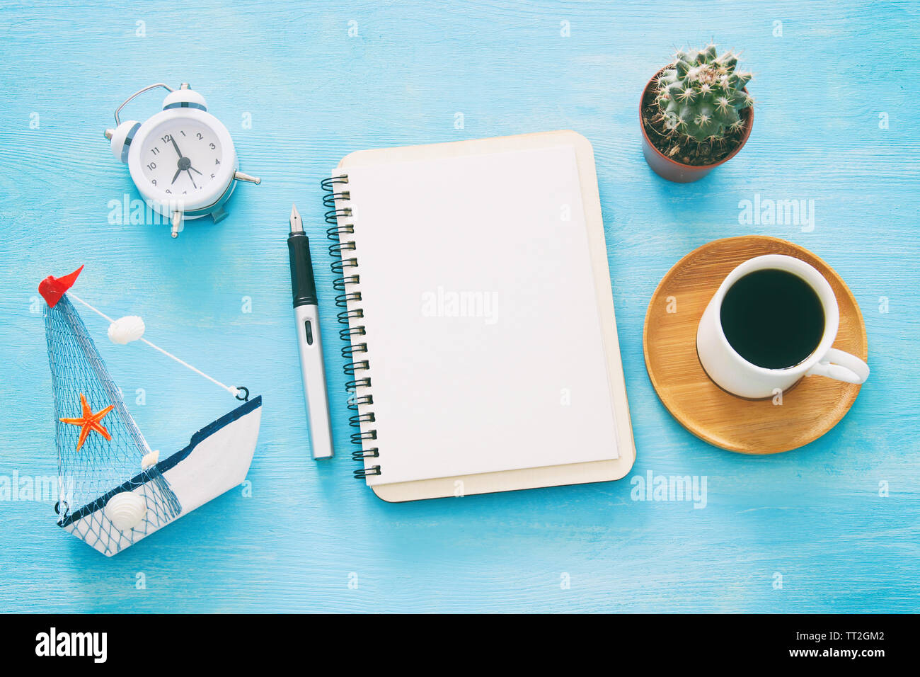 Open notebook with empty pages and other office supplies over blue ...