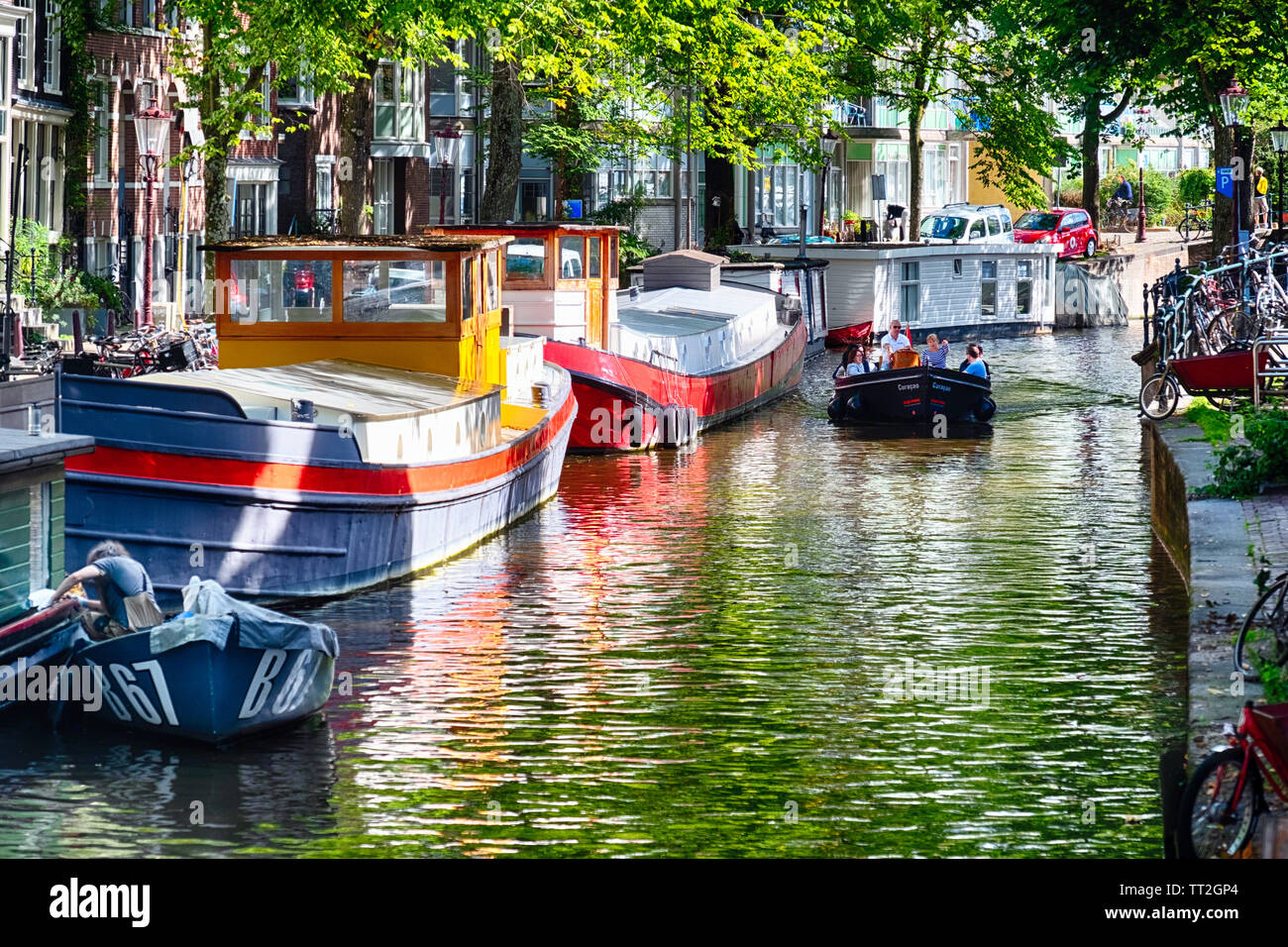 Small Canal with House Barges and a Tour Boat, Amsterdam, Netherlands ...