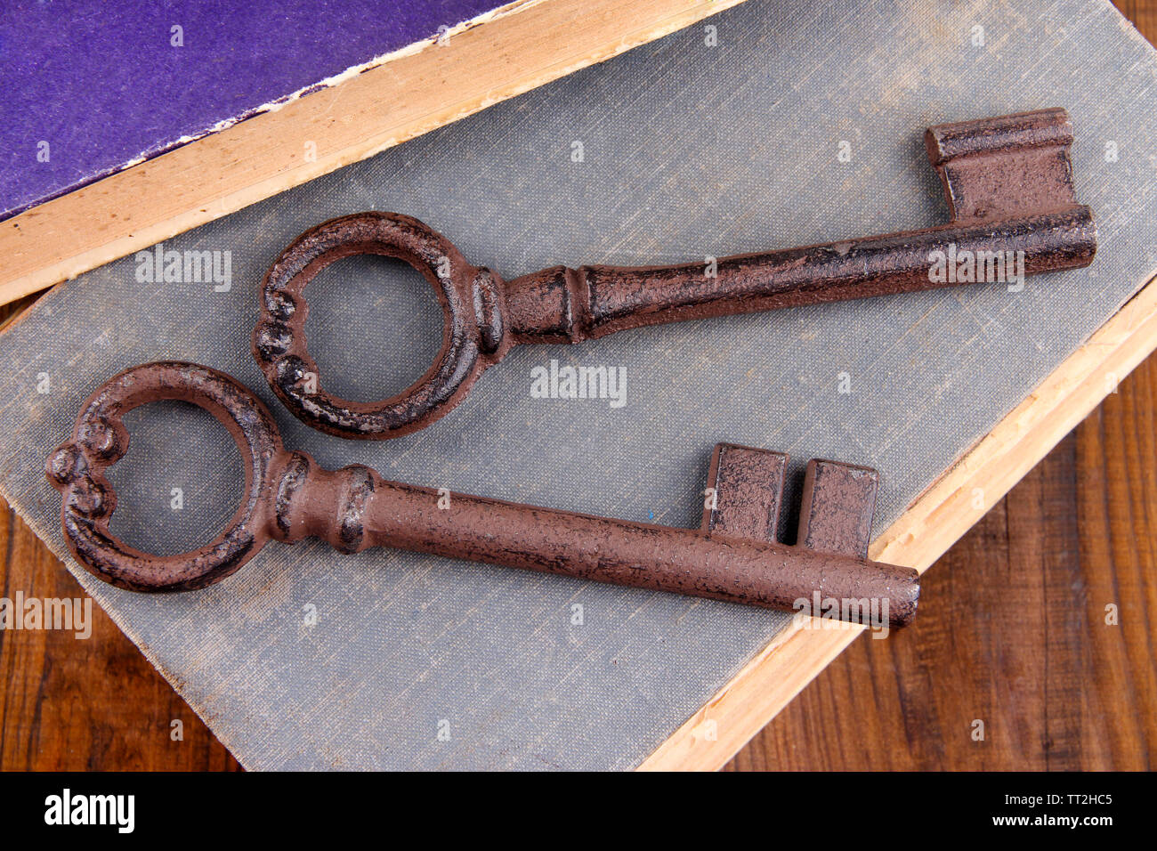 Old keys on old books on wooden background Stock Photo - Alamy