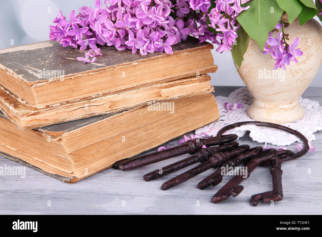 Beautiful composition with old keys and old books on bright background ...