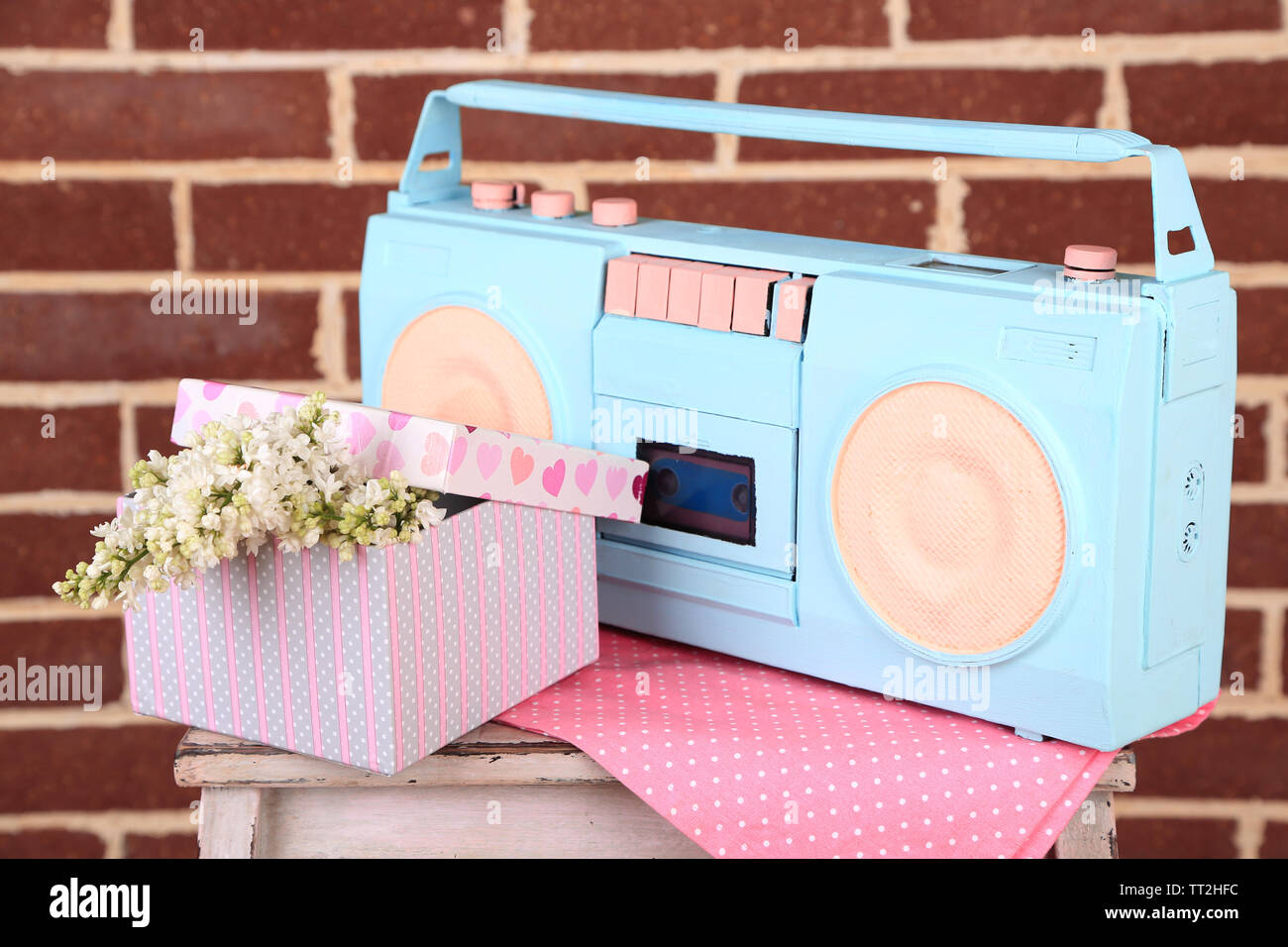 Still life with colorful retro radio, on brick wall wooden background ...
