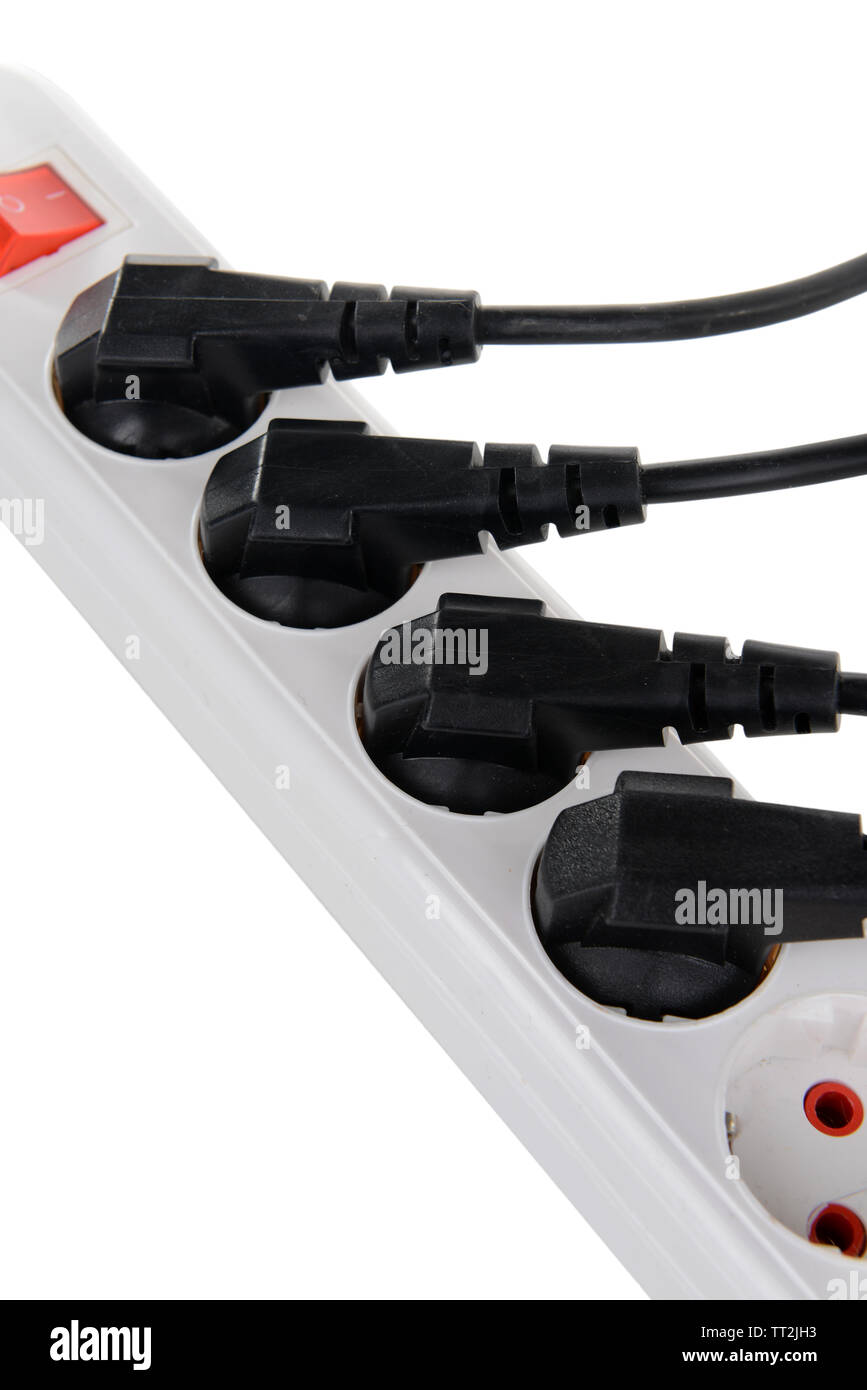 Many plugs plugged into electric power bar close-up Stock Photo - Alamy