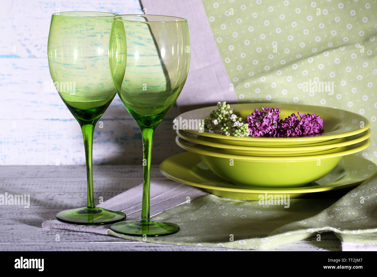 Green table settings, on table, on light background Stock Photo - Alamy