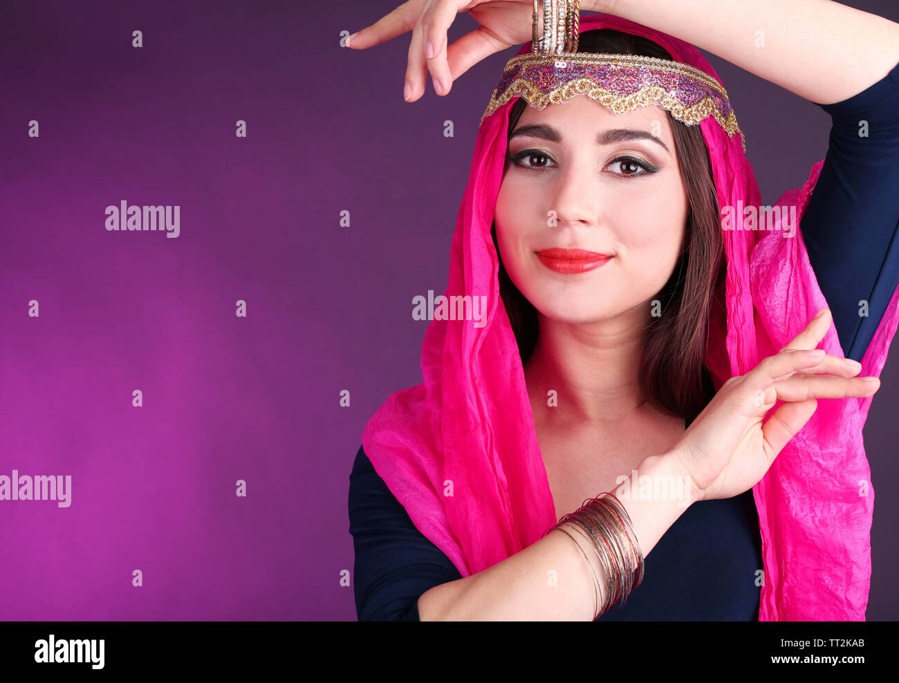 Beautiful oriental girl on dark colorful background Stock Photo - Alamy