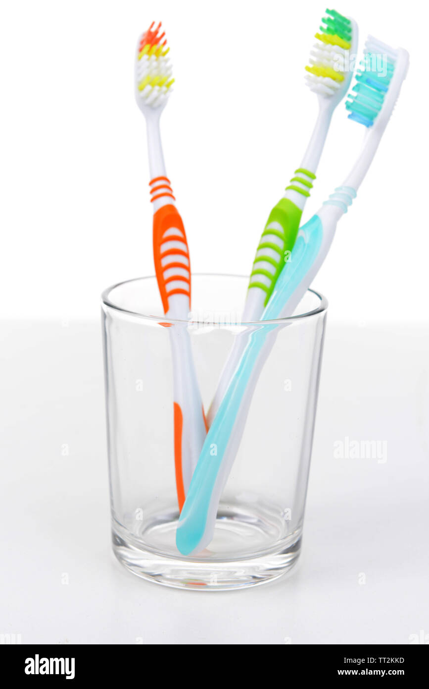 Toothbrushes in glass isolated on white Stock Photo - Alamy