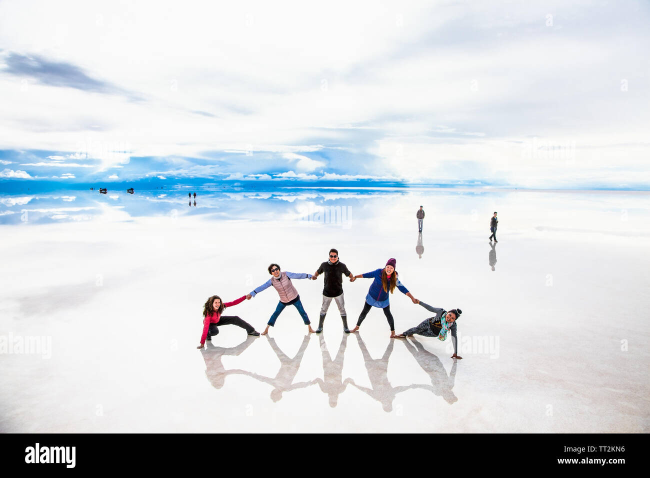 Uyuni, Bolivia- Dec 31, 2018: Group of people make figures with their ...