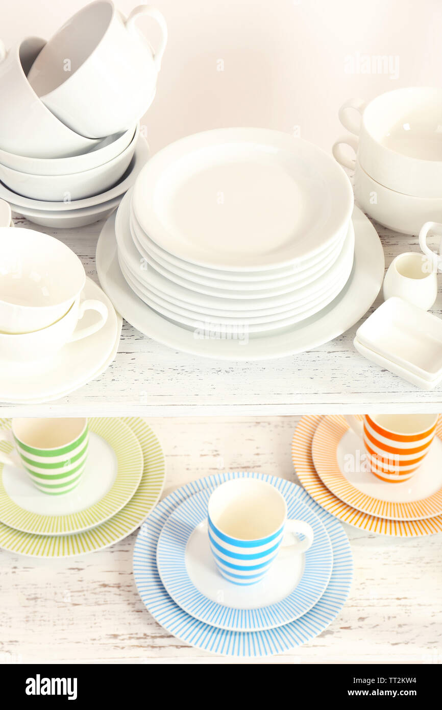 Different tableware on shelf, close up Stock Photo - Alamy