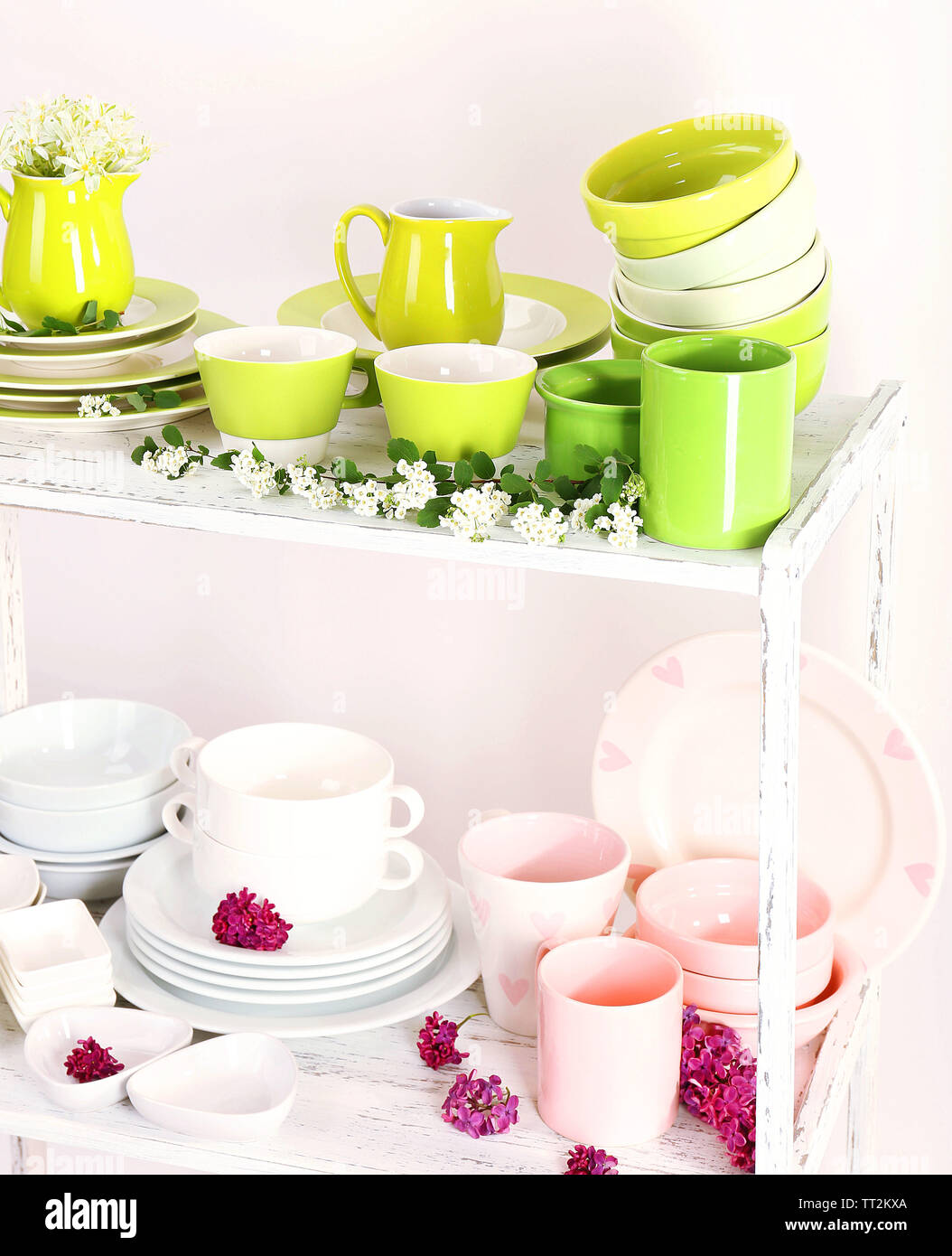 Different tableware on shelf, isolated on white Stock Photo - Alamy