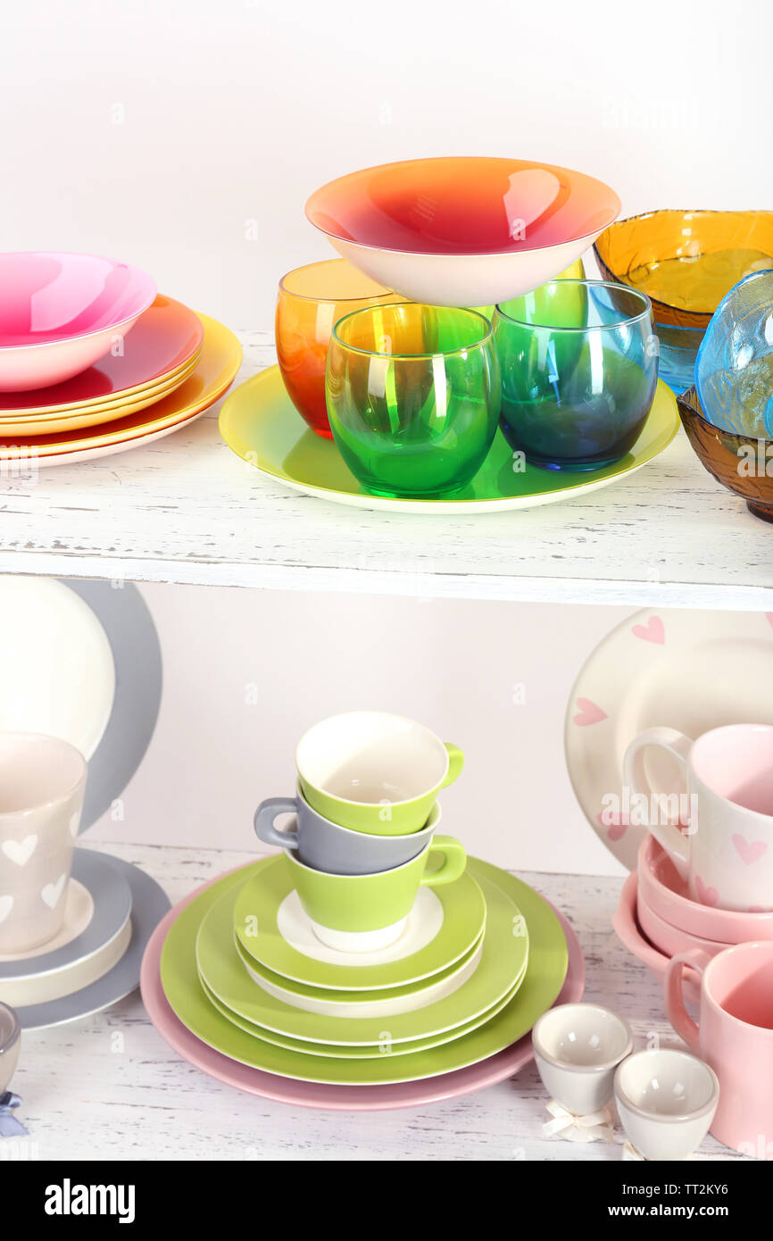 Different tableware on shelf, isolated on white Stock Photo - Alamy