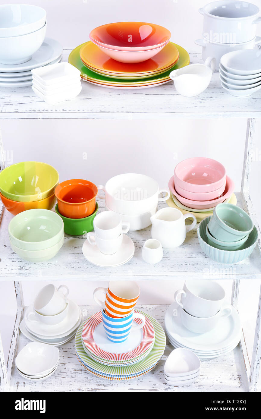 Different tableware on shelf, isolated on white Stock Photo - Alamy