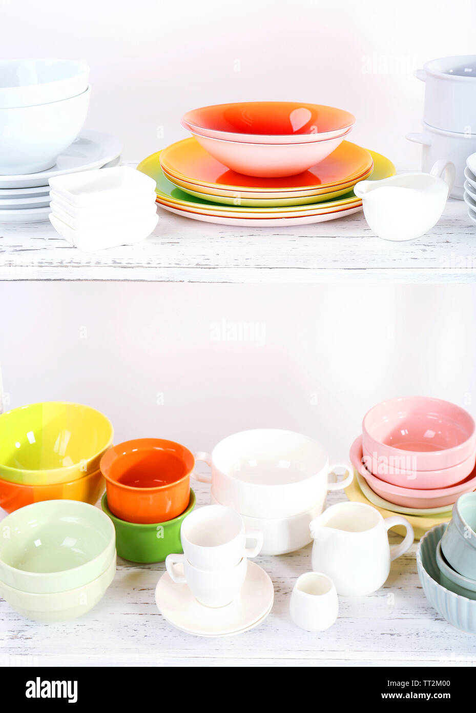 Different tableware on shelf, isolated on white Stock Photo - Alamy