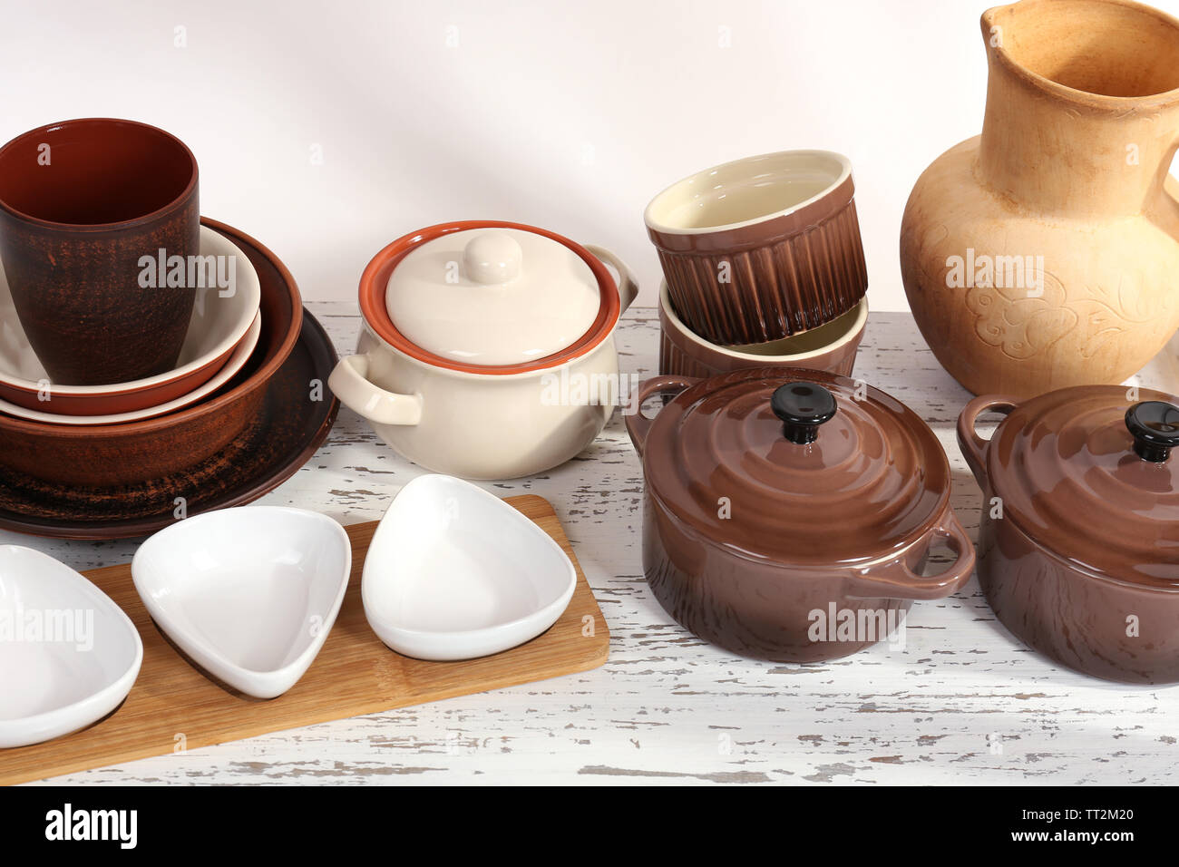 Different tableware on shelf, isolated on white Stock Photo - Alamy