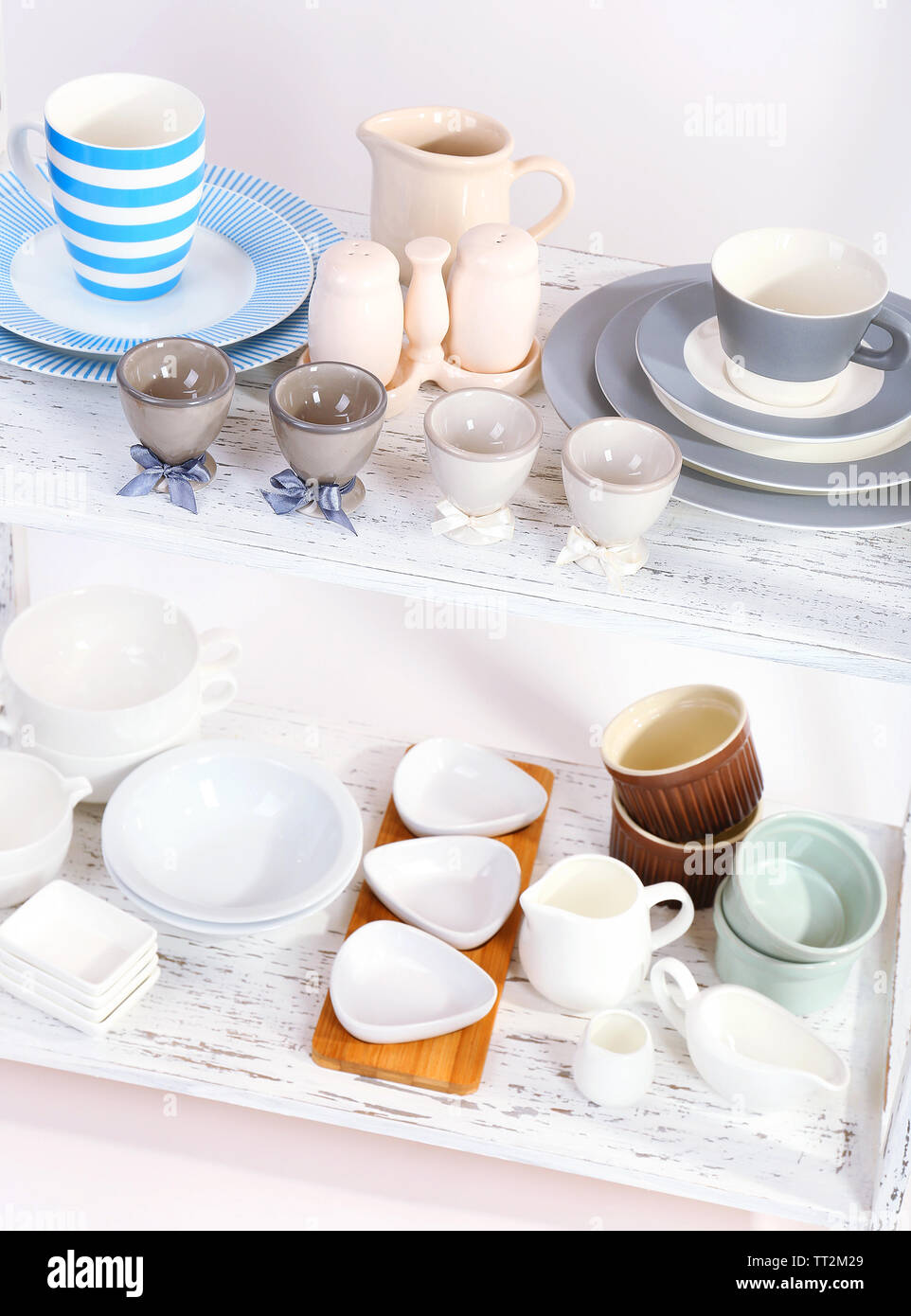 Different tableware on shelf, isolated on white Stock Photo - Alamy