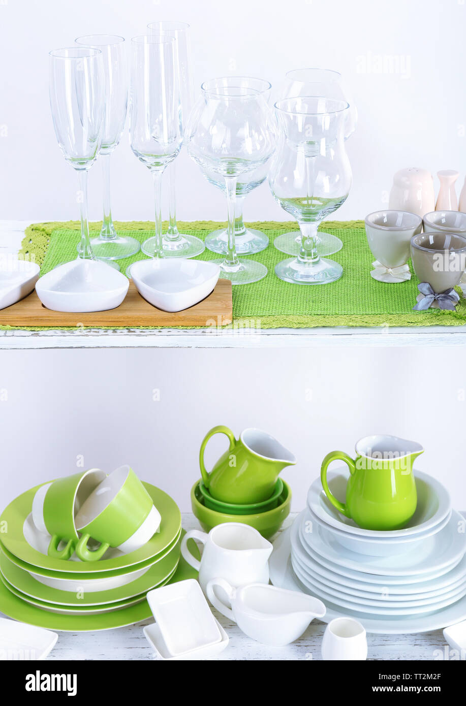 Different tableware on shelf, isolated on white Stock Photo - Alamy