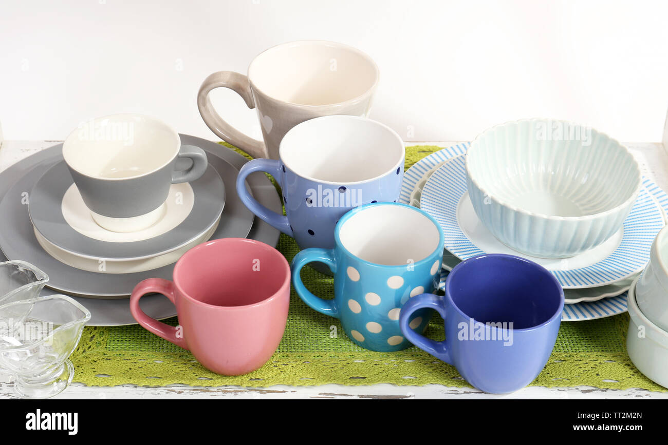 Different tableware on shelf, isolated on white Stock Photo - Alamy