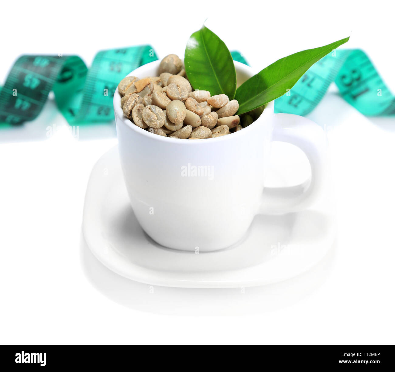 Raw green coffee beans in cup and measuring tape, isolated on white ...