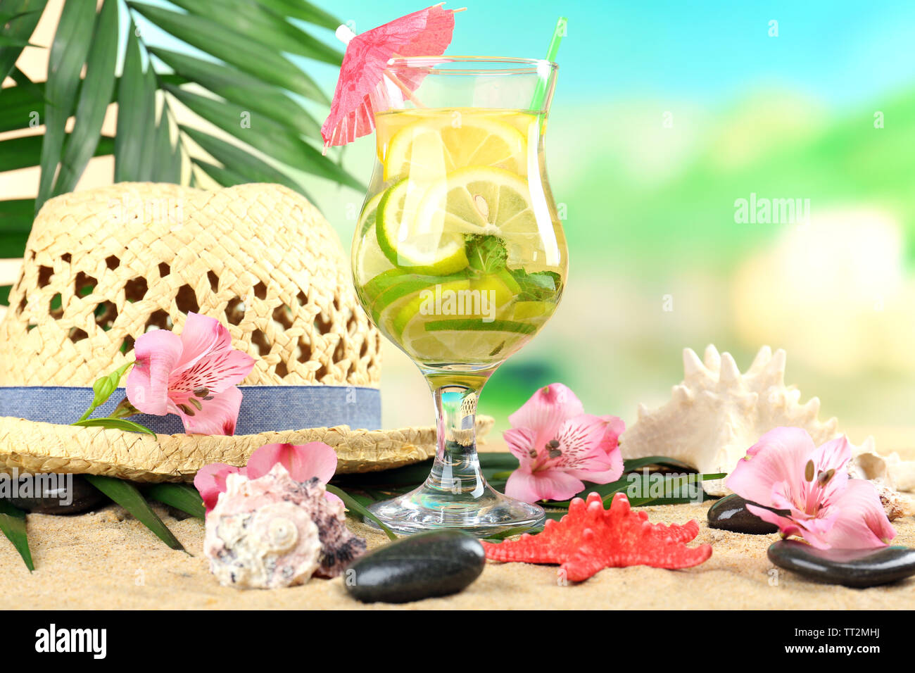 Refreshing cocktail on sand beach Stock Photo - Alamy