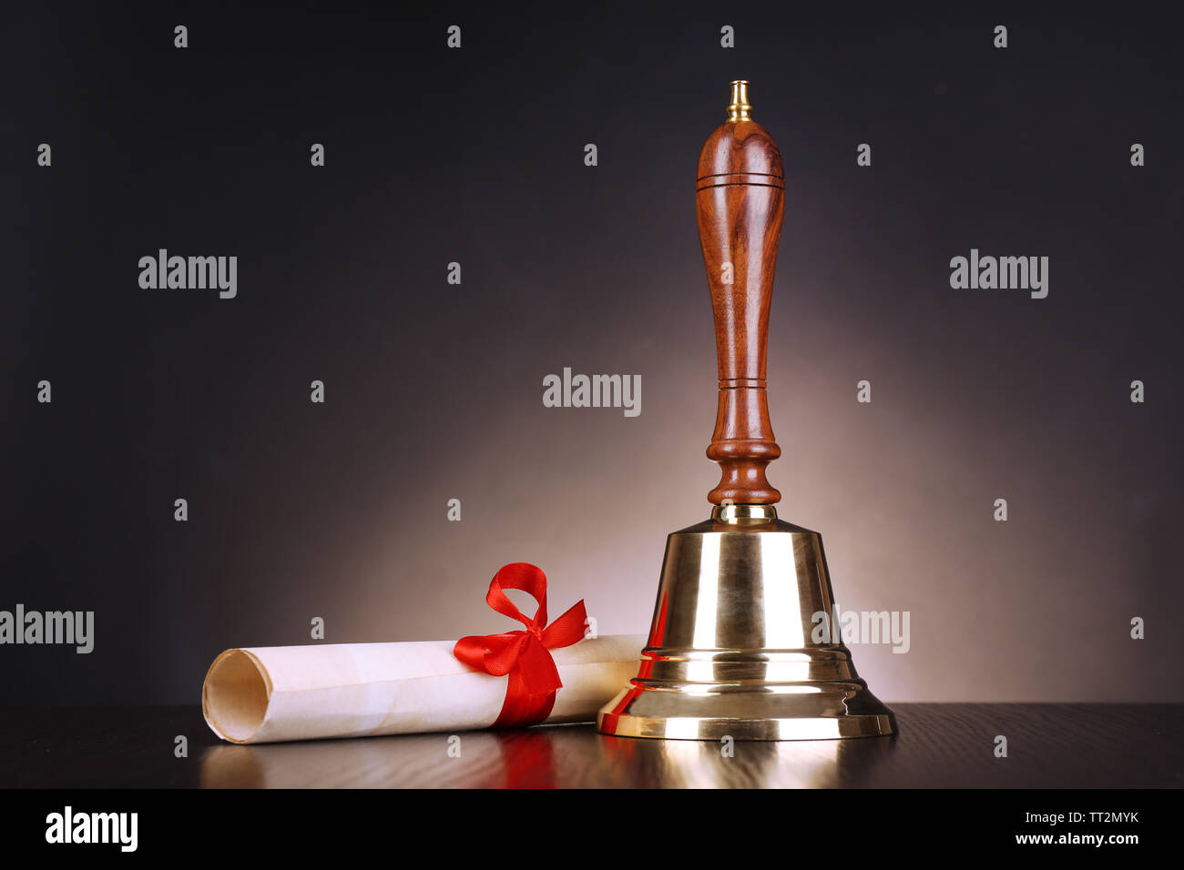 Gold retro school bell with scroll on dark background Stock Photo - Alamy
