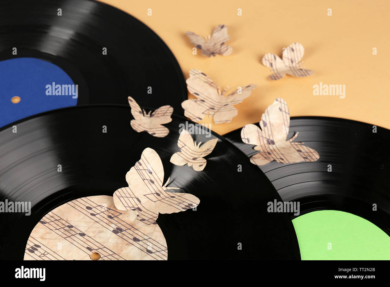 Old vinyl records with paper butterflies, on brown background Stock ...