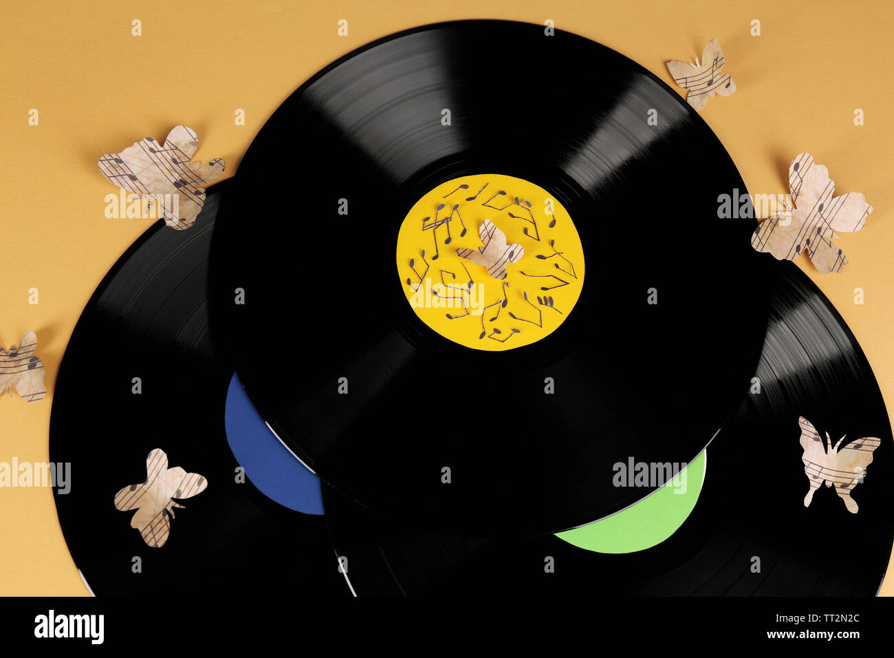 Old vinyl records with paper butterflies, on brown background Stock ...