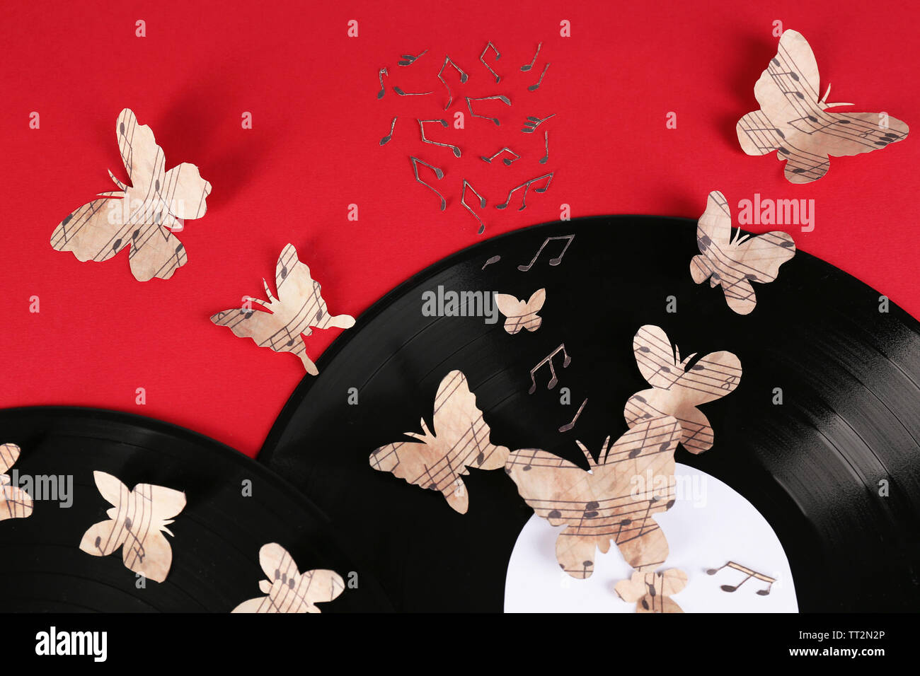 Old vinyl records with paper butterflies, on red background Stock Photo ...