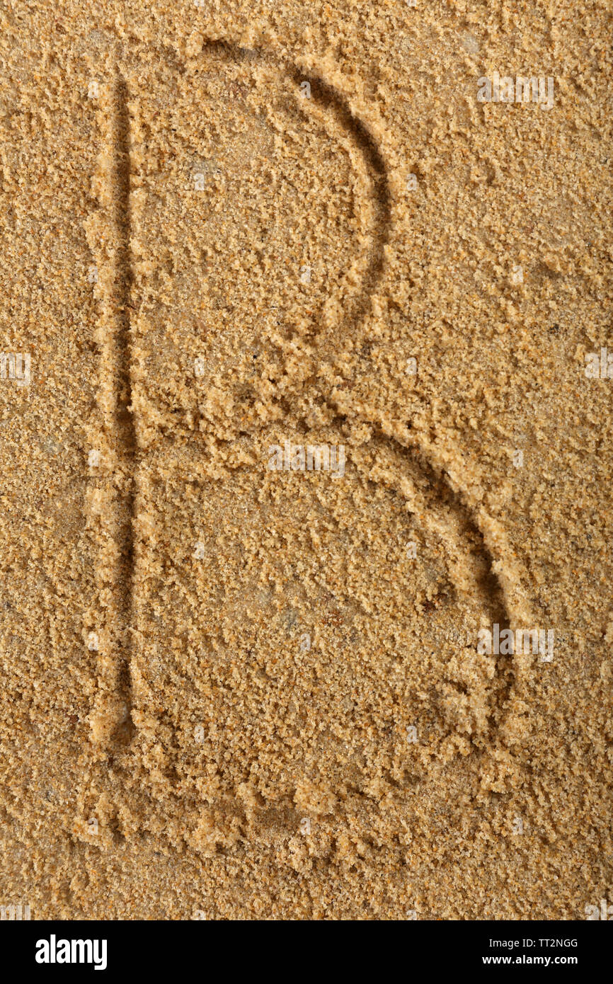 Alphabet letter written on wet beach sand Stock Photo - Alamy