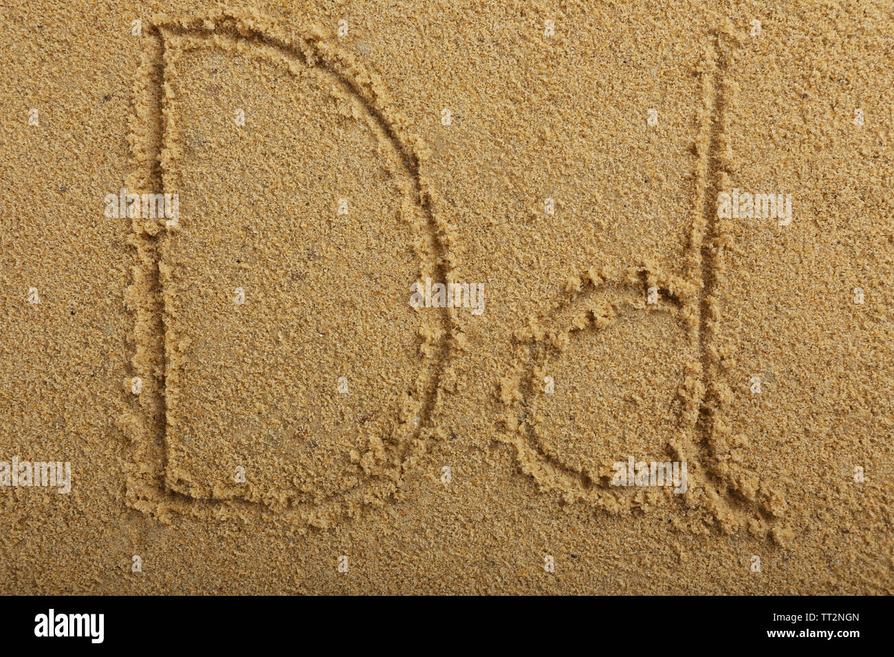 Alphabet letter written on wet beach sand Stock Photo - Alamy