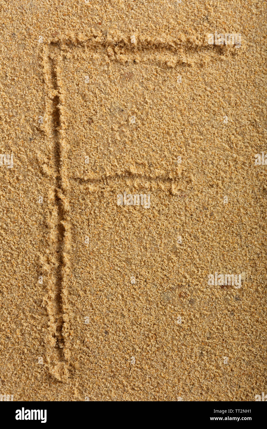 Alphabet letter written on wet beach sand Stock Photo - Alamy
