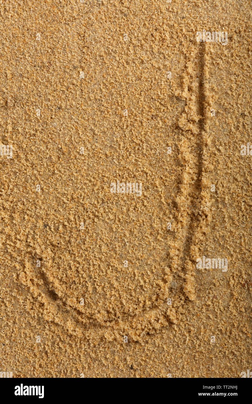 Alphabet letter written on wet beach sand Stock Photo - Alamy