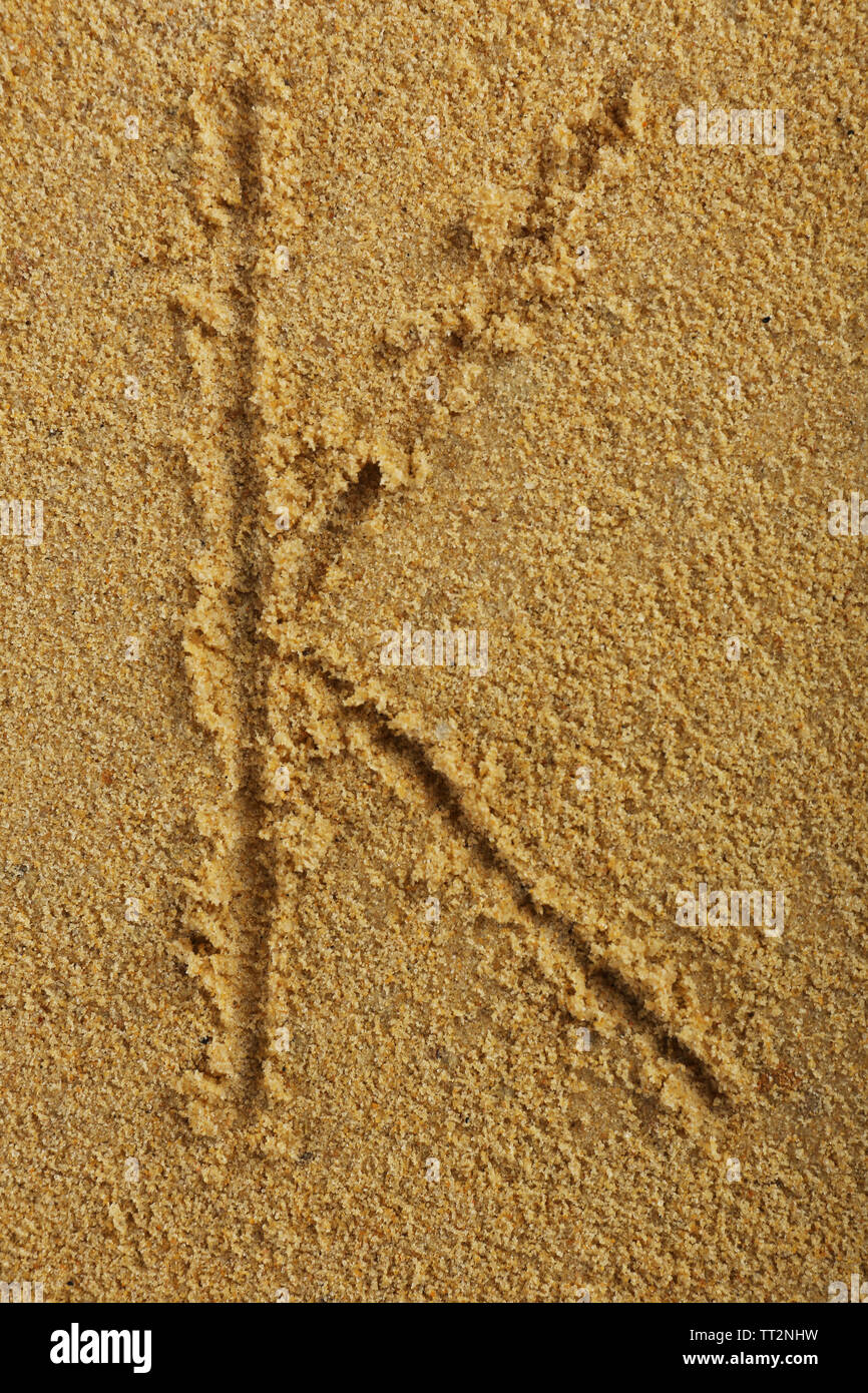 Alphabet letter written on wet beach sand Stock Photo - Alamy