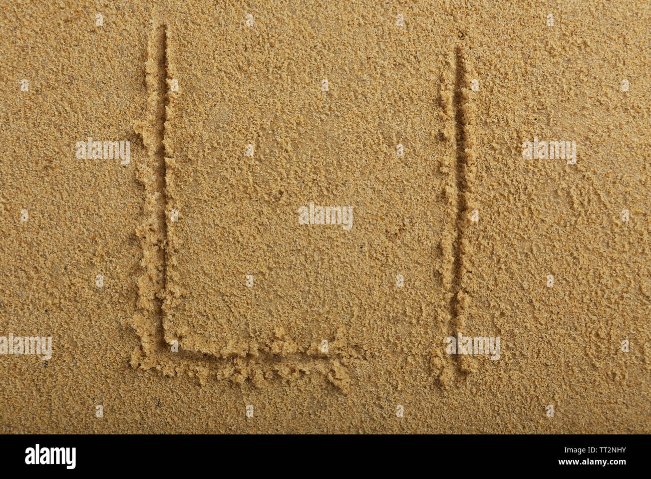 Alphabet letter written on wet beach sand Stock Photo - Alamy